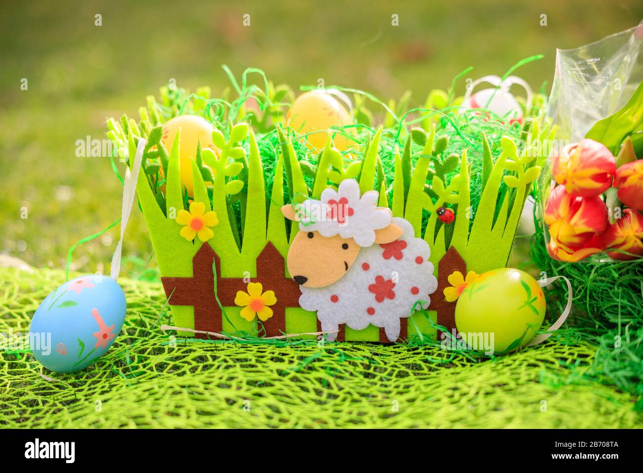 Colorful Easter eggs decorated with flowers in the grass background ...
