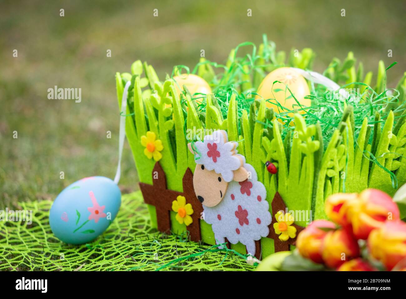 Colorful Easter eggs decorated with flowers in the grass background ...