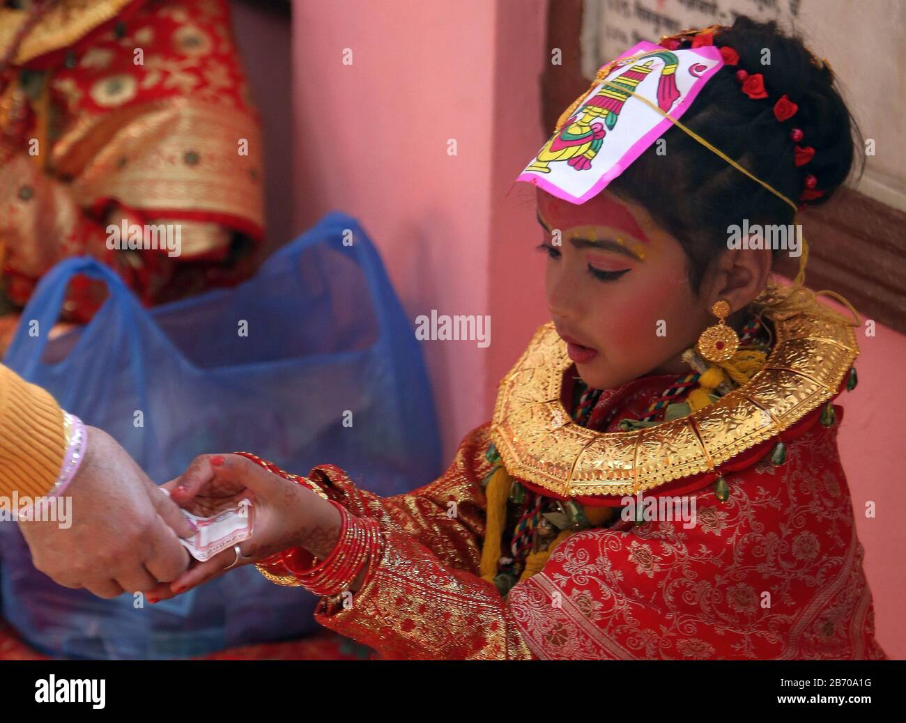 Kavre, Nepal. 12th Mar, 2020. A small girl from Newar community receive ...