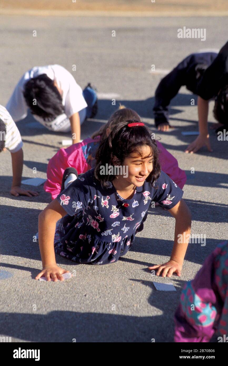 San Antonio, Texas: Fifth graders exercising on playground during ...