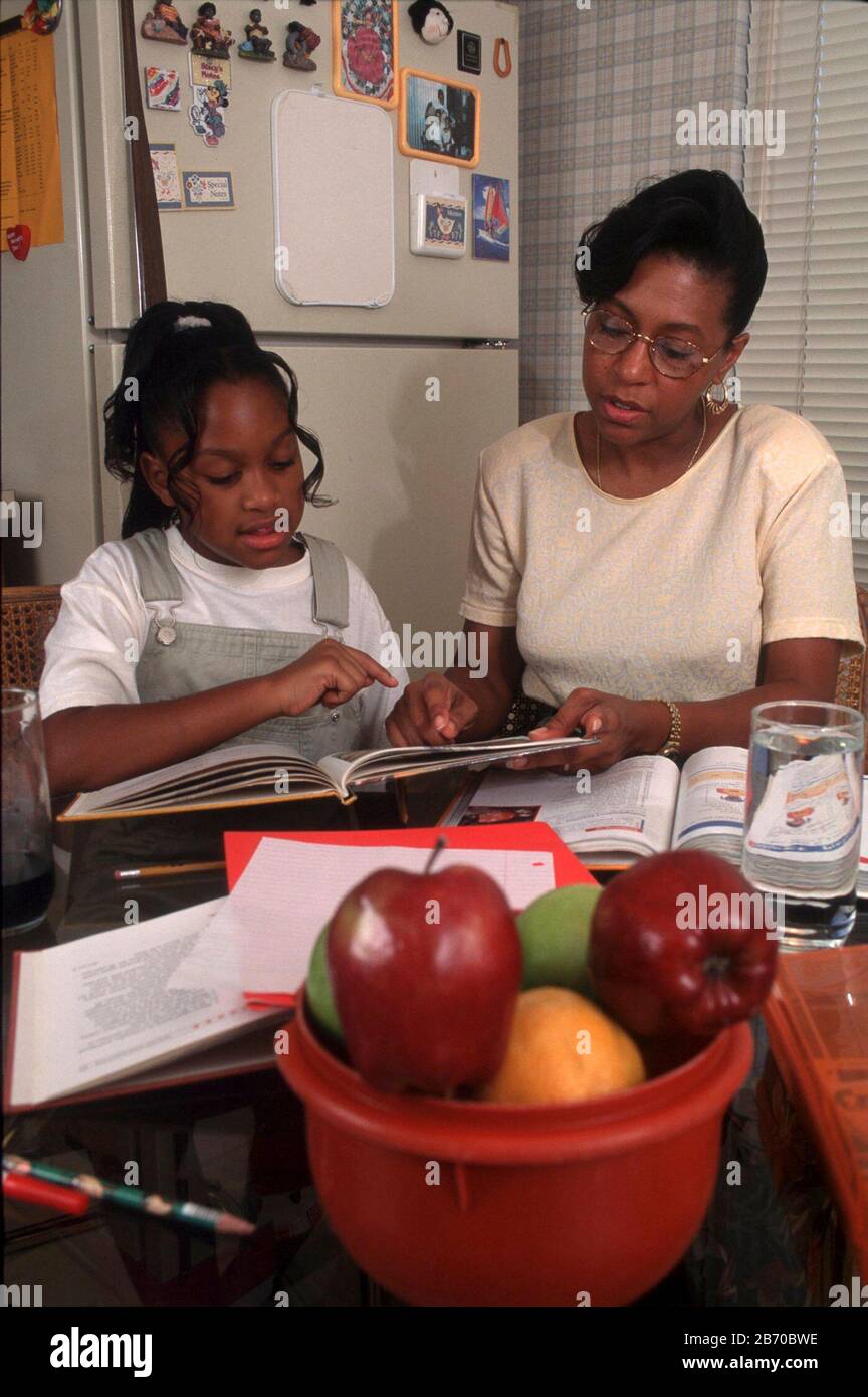 Mom reviewing childs homework hi-res stock photography and images - Alamy