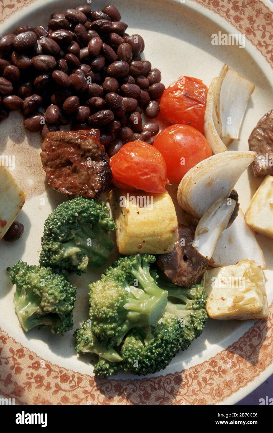 Plateful of fresh, healthy food: black beans, vegetables and small ...