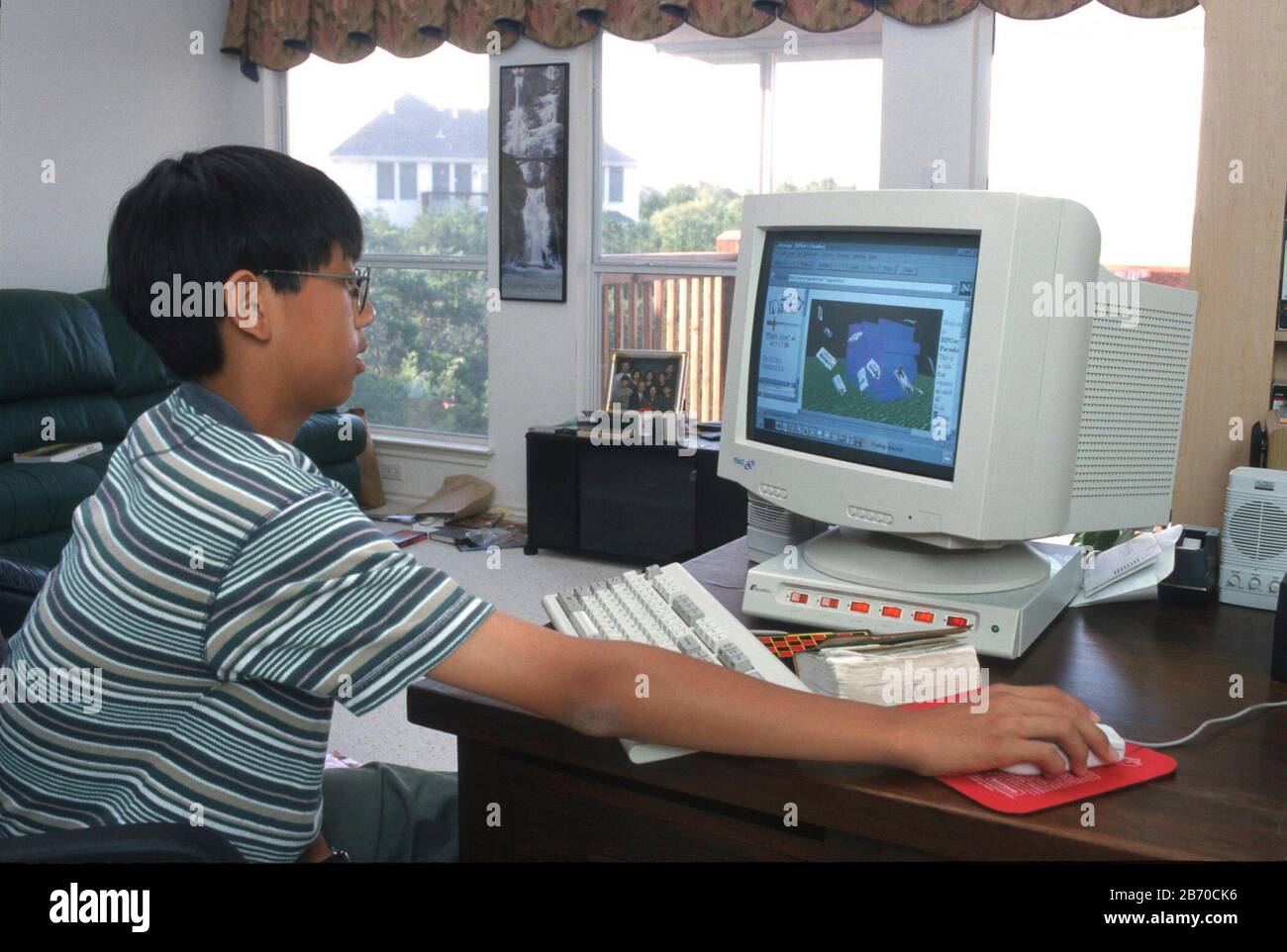 Austin, Texas USA, 1999: Asian-American teenage boy surfs the internet ...