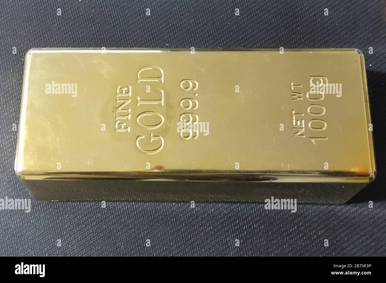 Gold ingot isolated close up Stock Photo - Alamy