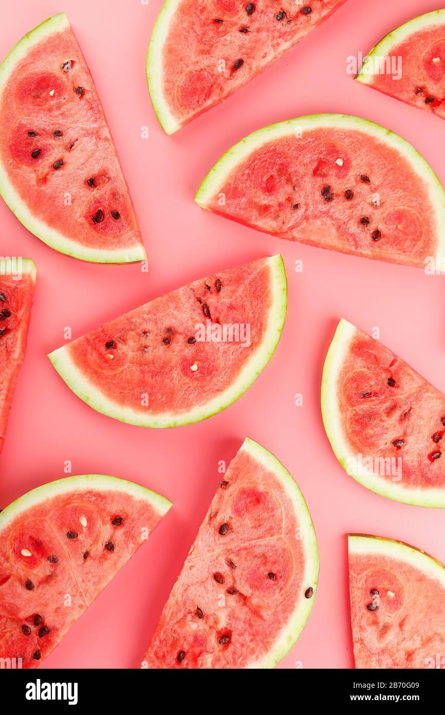 Juicy slices of red watermelon on a bright pink background. Conceptual ...