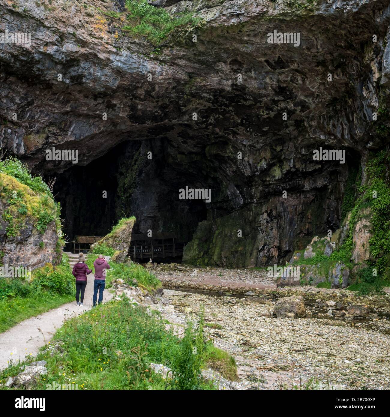 Smoo Cave, Durness, Scotland. A tourist couple adding scale to the ...