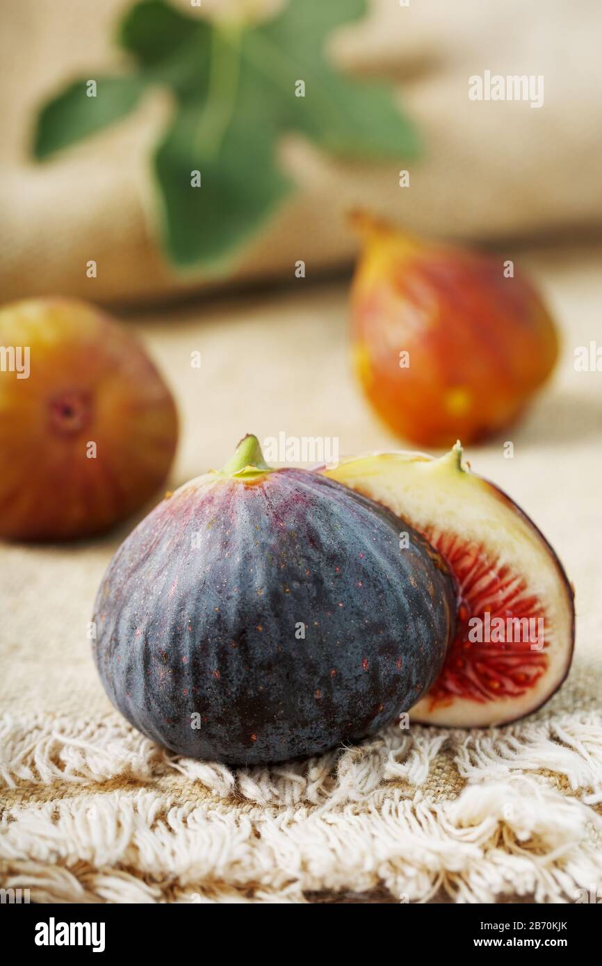 Ripe organic figs on the table. Group of purple and green figs on a ...