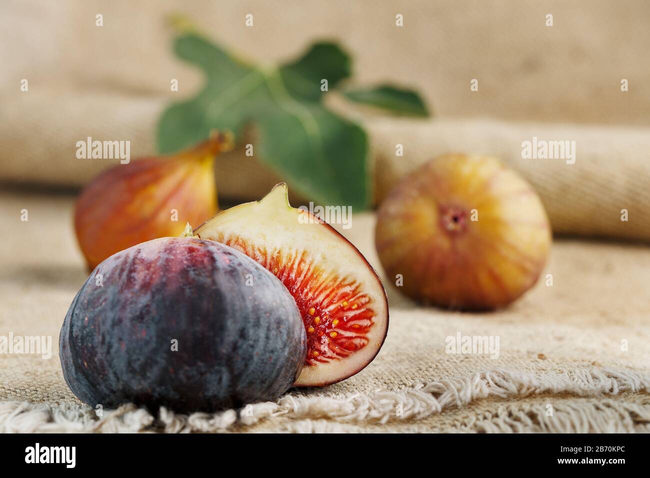 Figs on the table, group of fruits on a wooden farm table with burlap ...