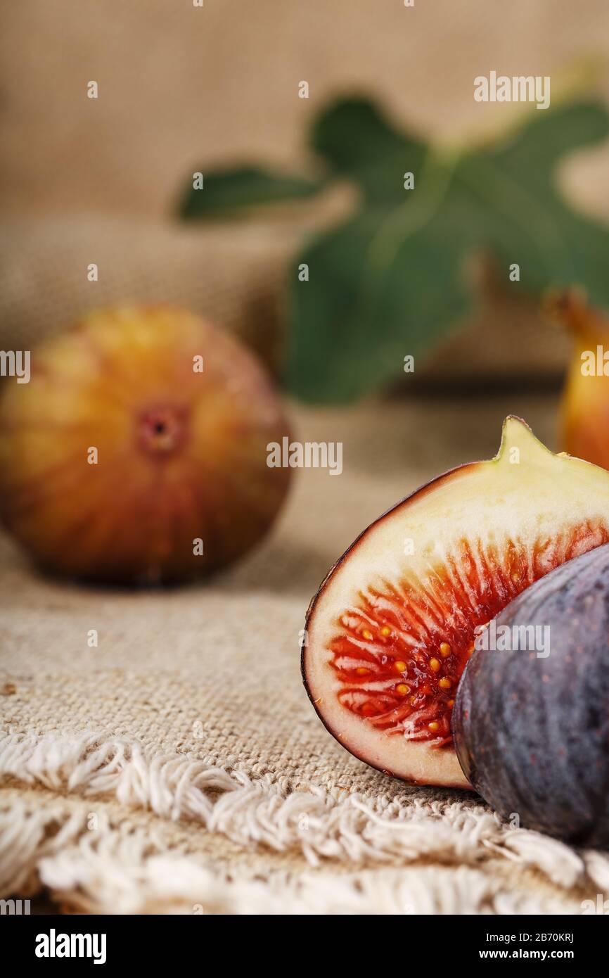 Figs on the table, group of fruits on a wooden farm table with burlap ...