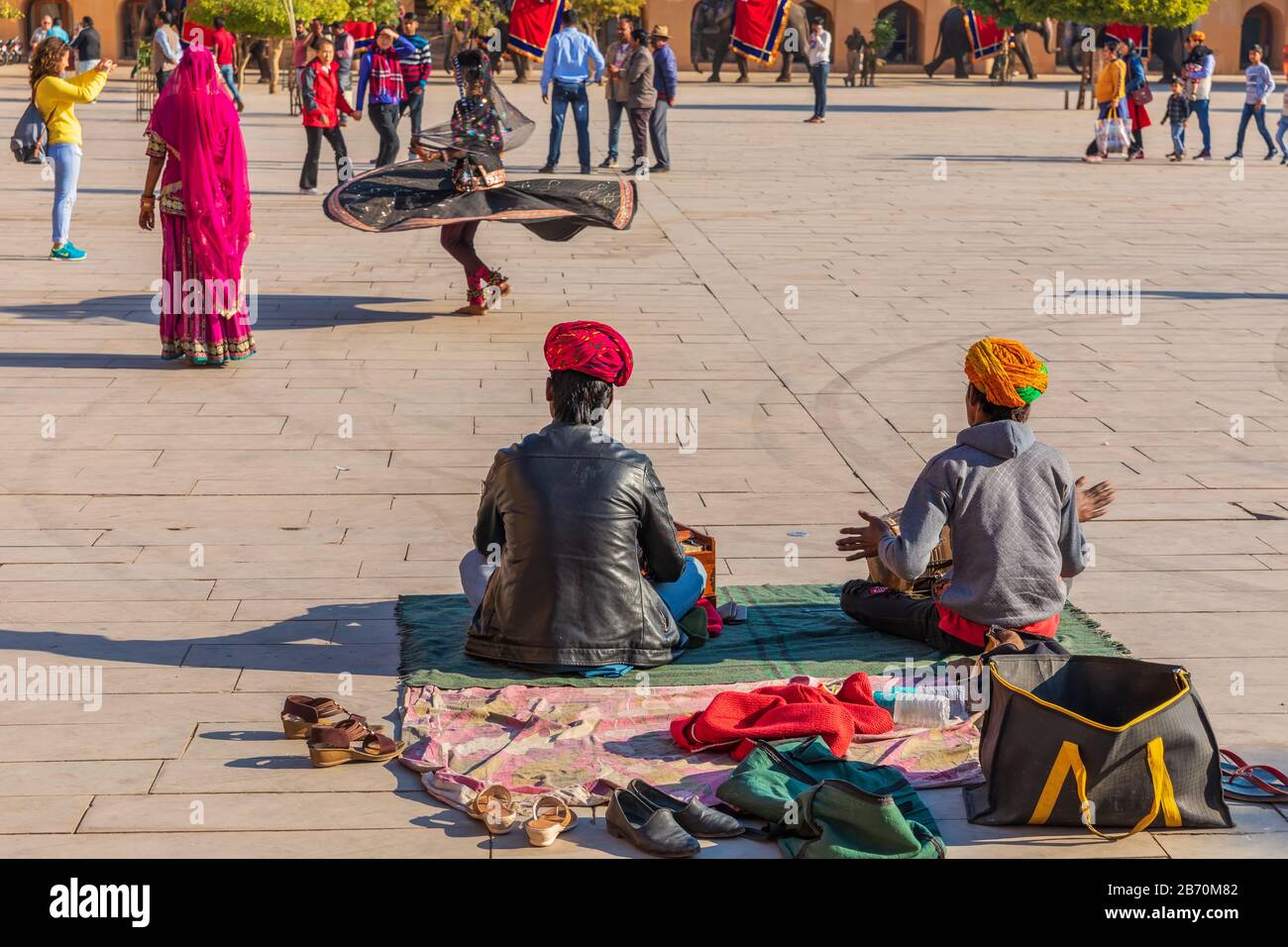 Indian men playing the tabla and the santur while Indian woman are ...