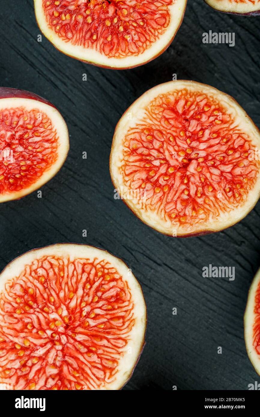 Ripe Figs. Creative diagram of chopped figs on a black textural ...