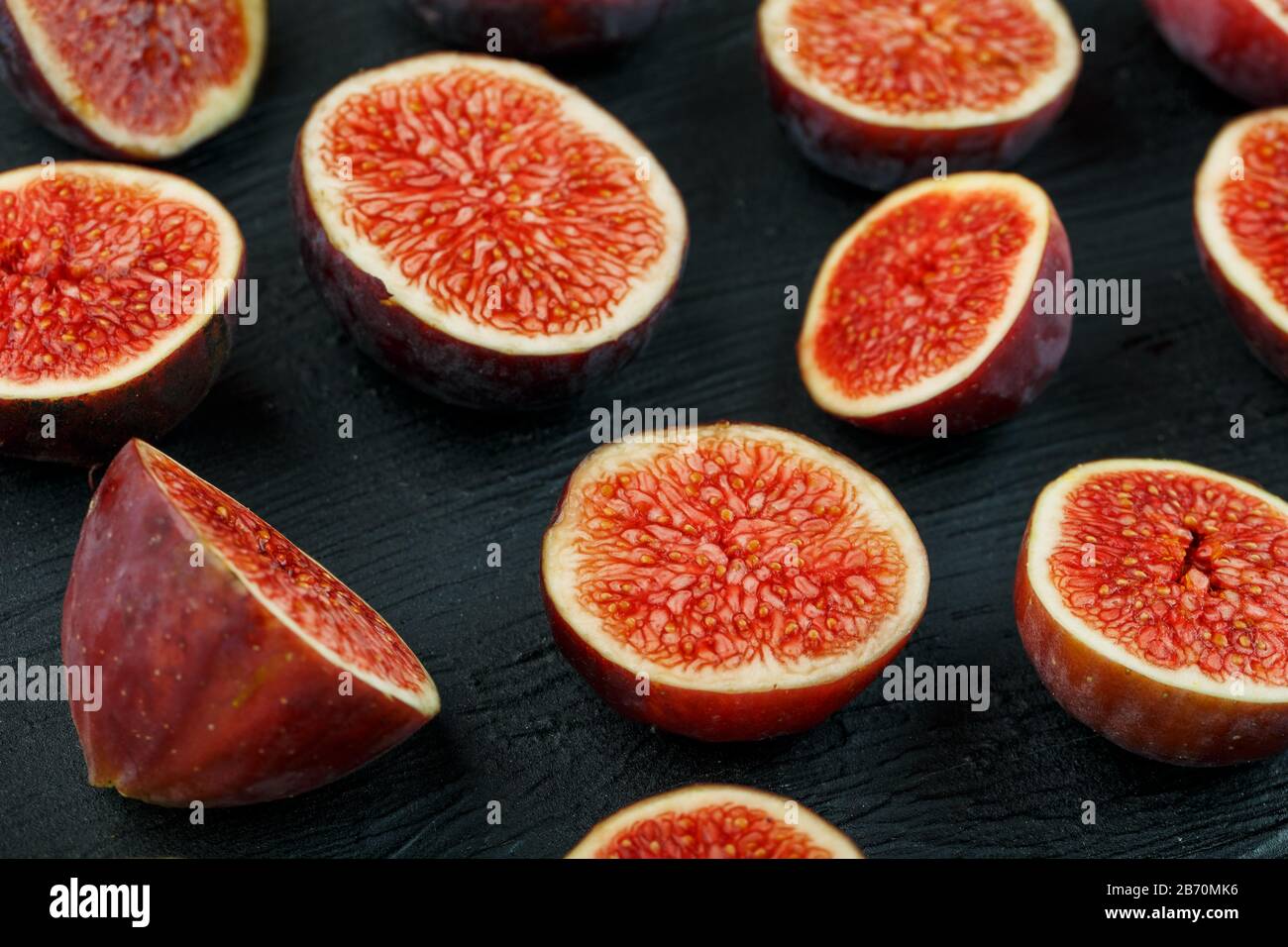Ripe Figs. Creative diagram of chopped figs on a black textural ...