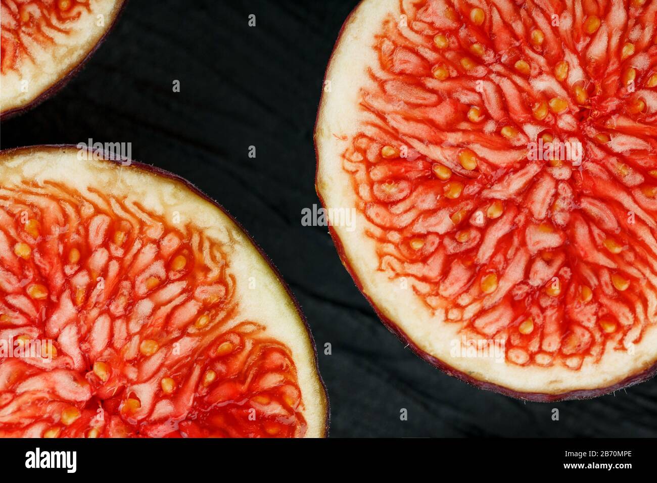 Figs are ripe. Closeup of sliced fig fruits in the form of a texture ...