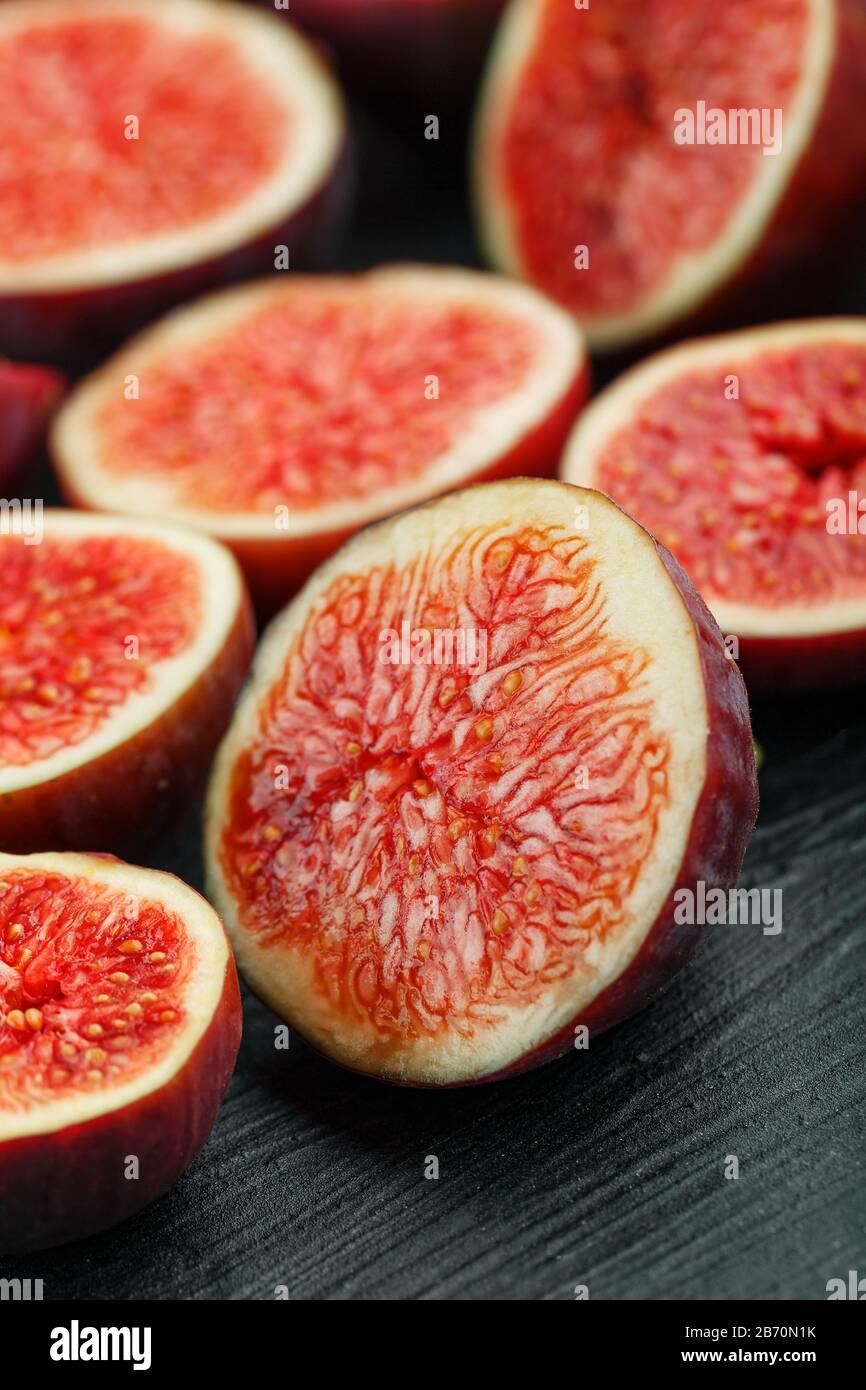 Ripe Figs. Creative diagram of chopped figs on a black textural ...