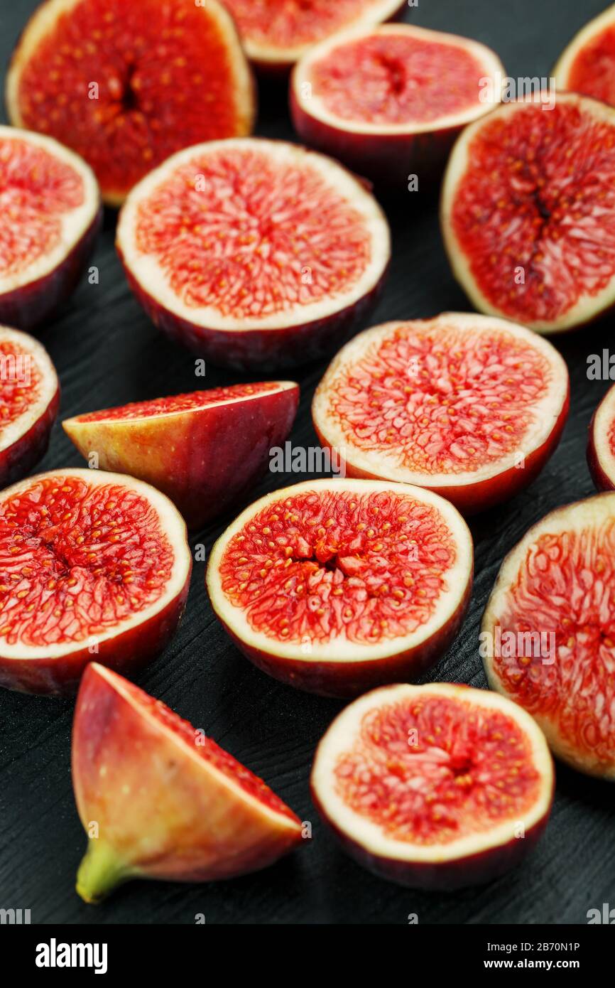 Ripe Figs. Creative diagram of chopped figs on a black textural ...