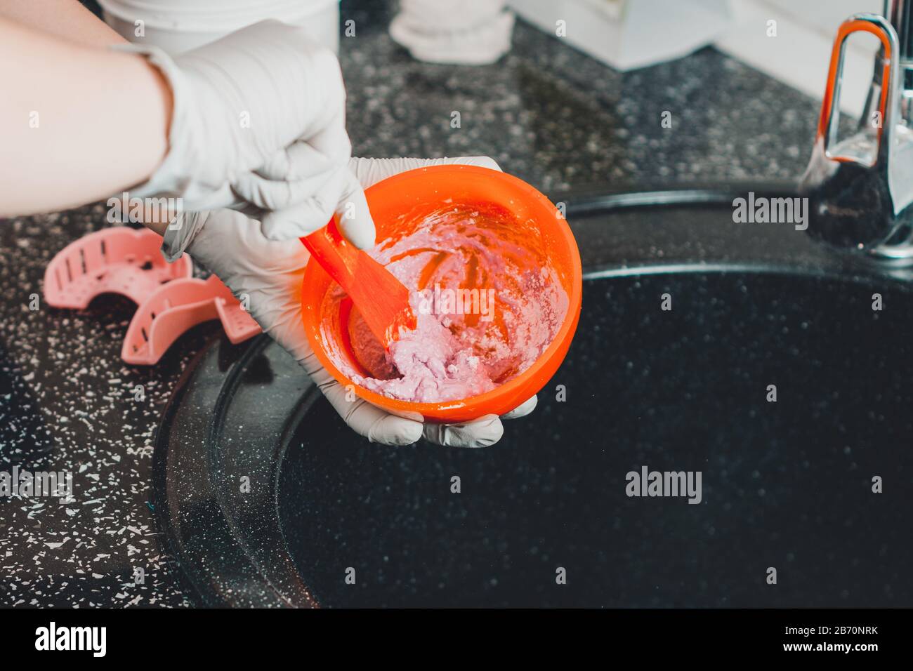 Alginate impression, orthodontist prepares a pink mixture to measure ...