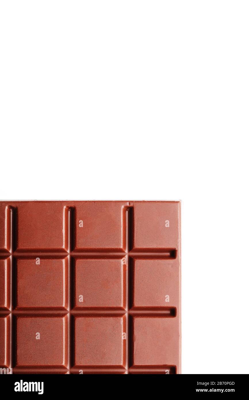 Square-shaped milk chocolate on a white background from above. Isolated ...