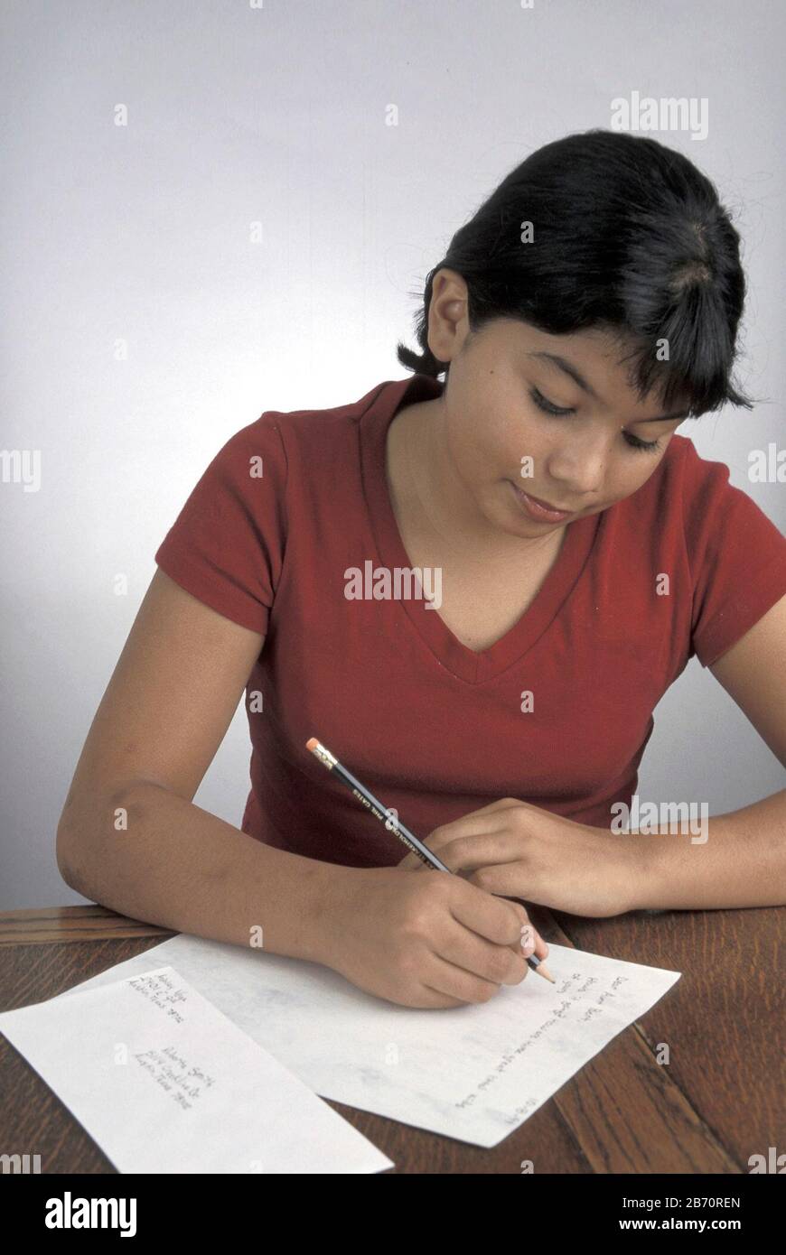 Austin, Texas USA: 13-year-old Hispanic girl writing a letter to a ...
