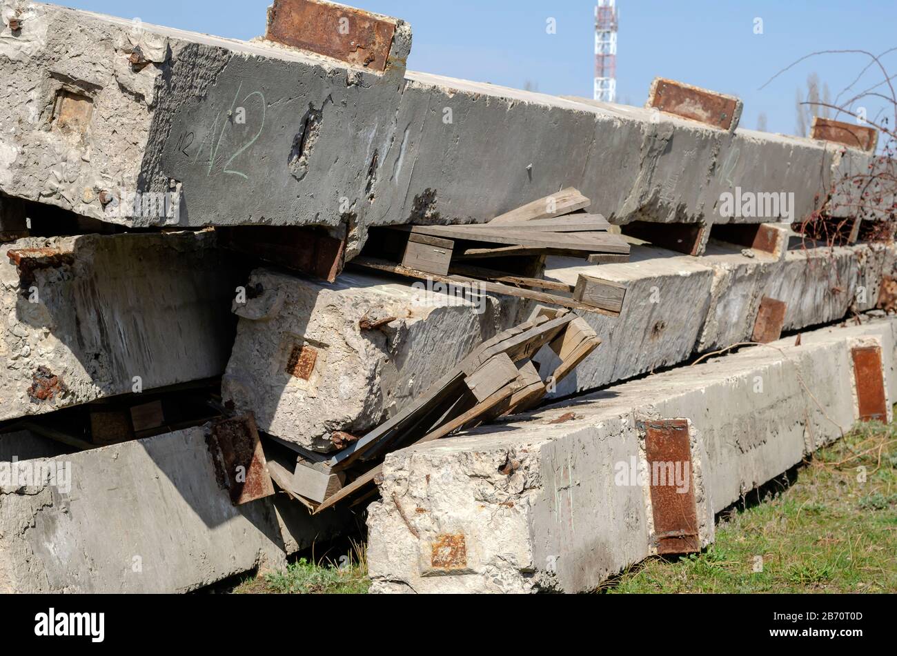 Used concrete piles outdoors. A group of old reinforced concrete ...