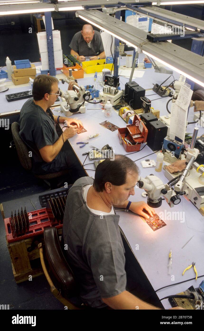 Lockhart, Texas USA: Inmates use magnifiers to makes circuit boards for ...