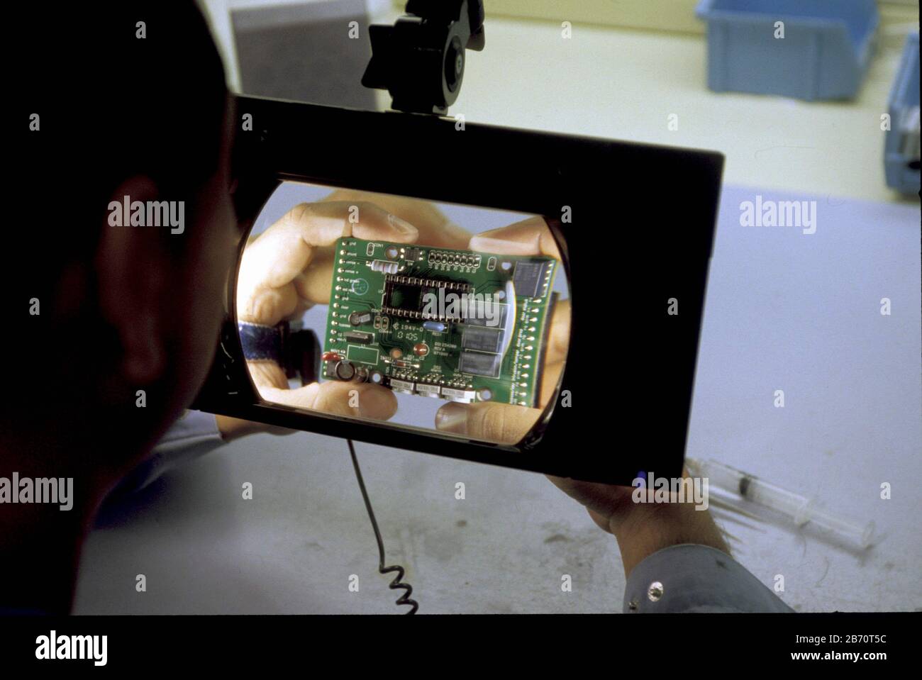 Lockhart, Texas USA: Inmate uses magnifier to makes circuit boards for ...