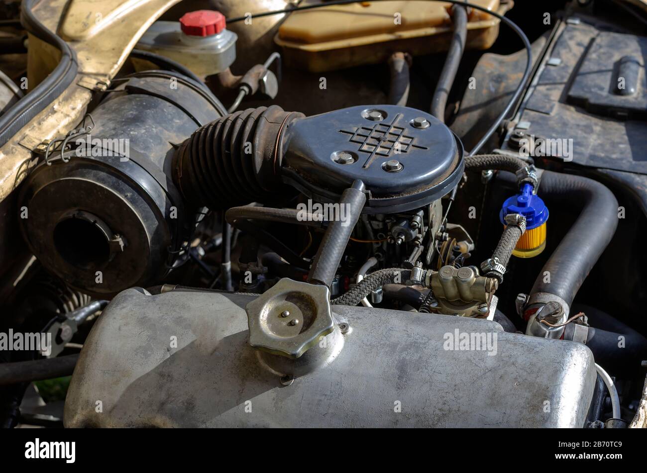 Engine compartment of an old car. Cylinder head cover, filter and ...