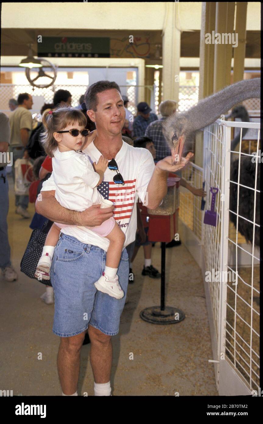 Dallas, Texas USA, October 2001: Father holds daughter in arm while he ...