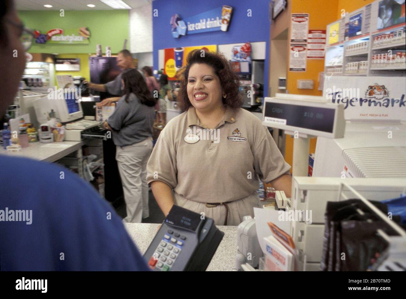 Austin, Texas USA, 2004: ExxonMobil convenience store clerk (right ...
