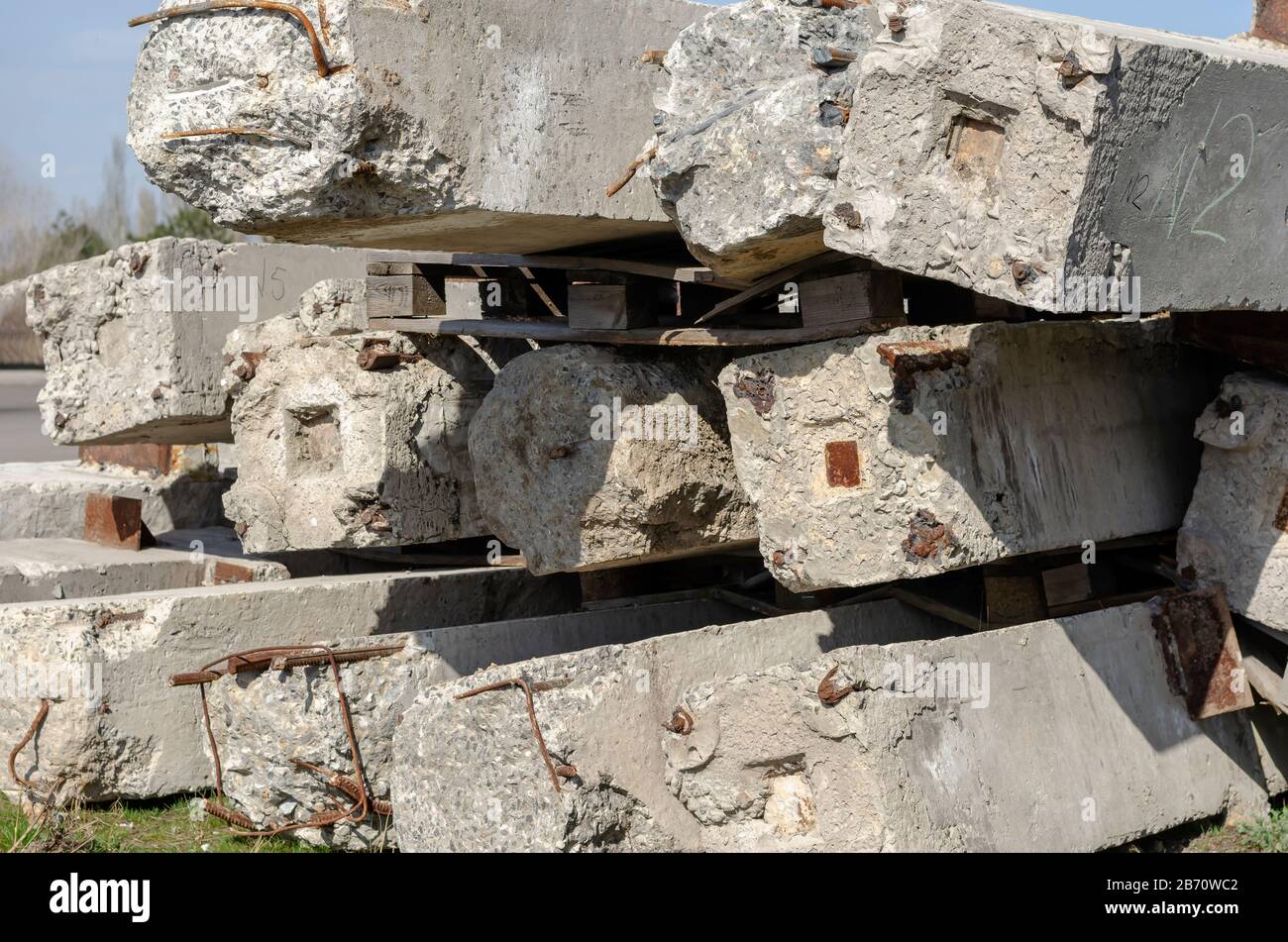 A pile of old concrete piles outdoors. Used reinforced concrete ...