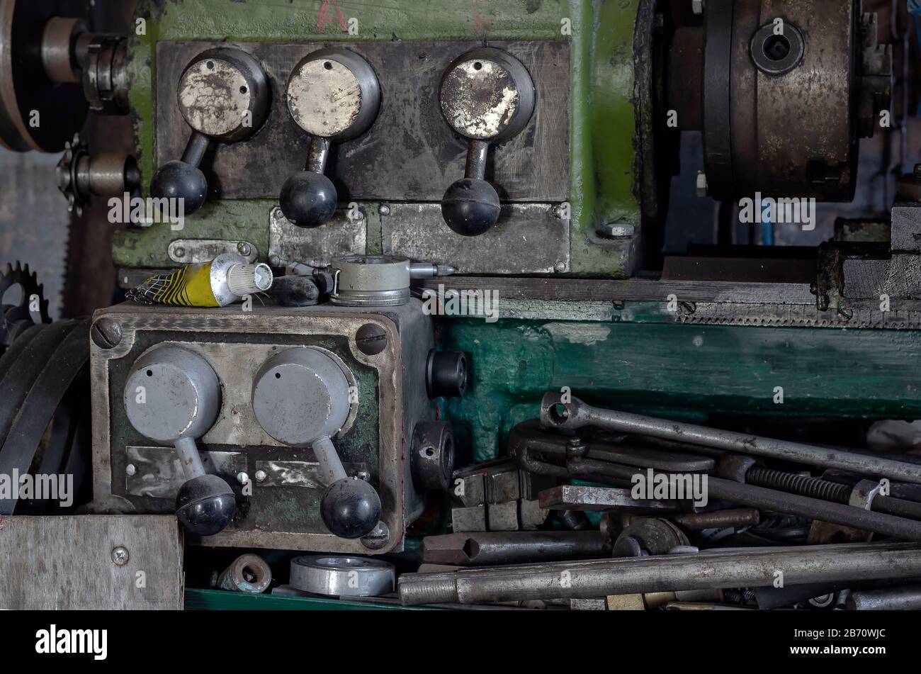 Local perspective on old machine equipment. Fragment of an old lathe ...