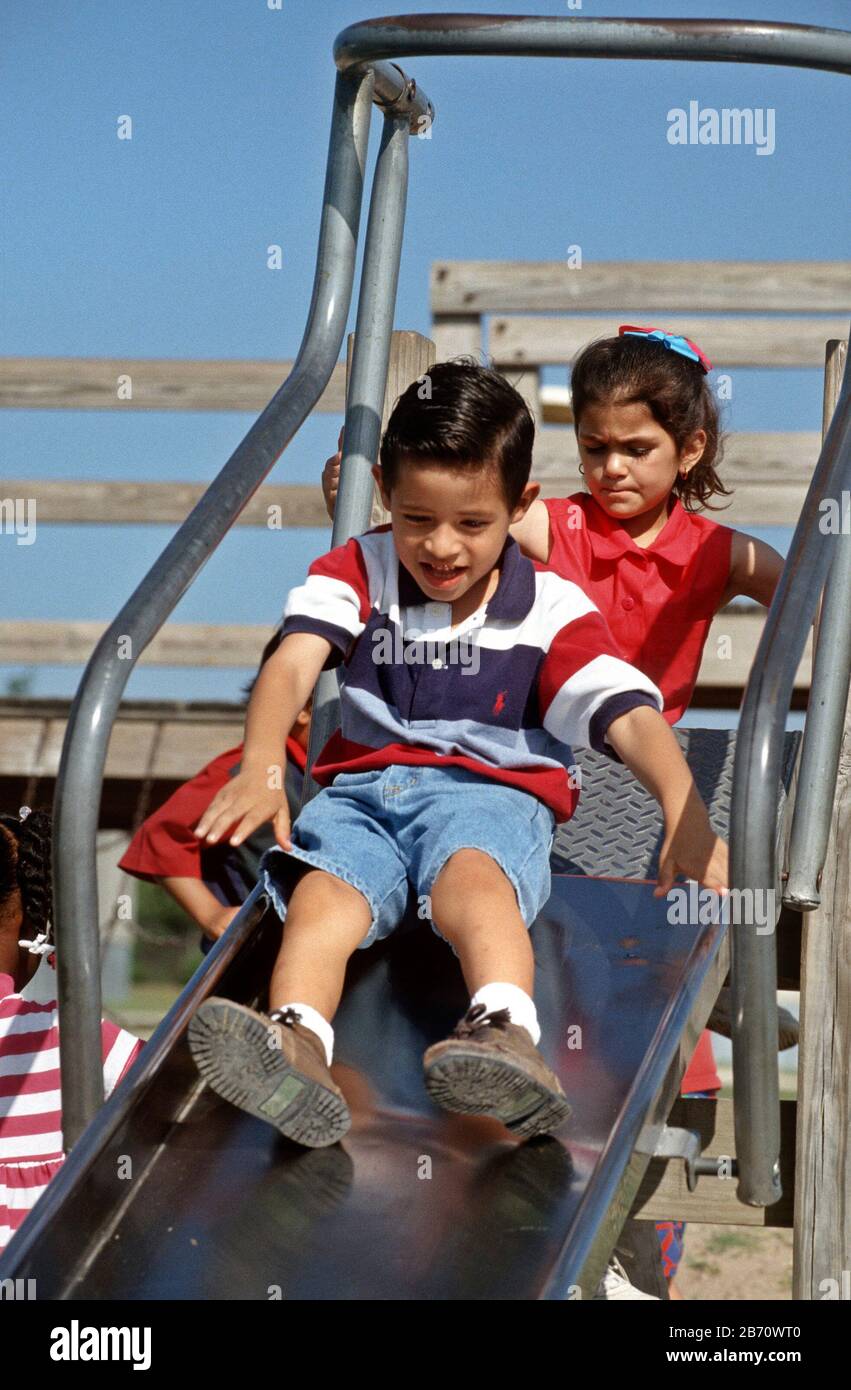 Austin Texas USA: Kindergarten students on slide, using safe sliding ...
