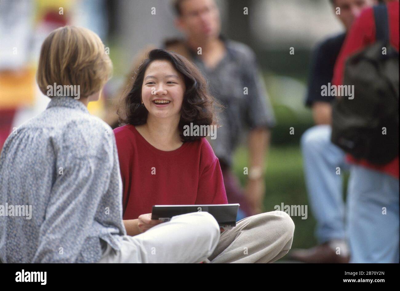 Austin, Texas: Women talking to friend while studying at University of ...