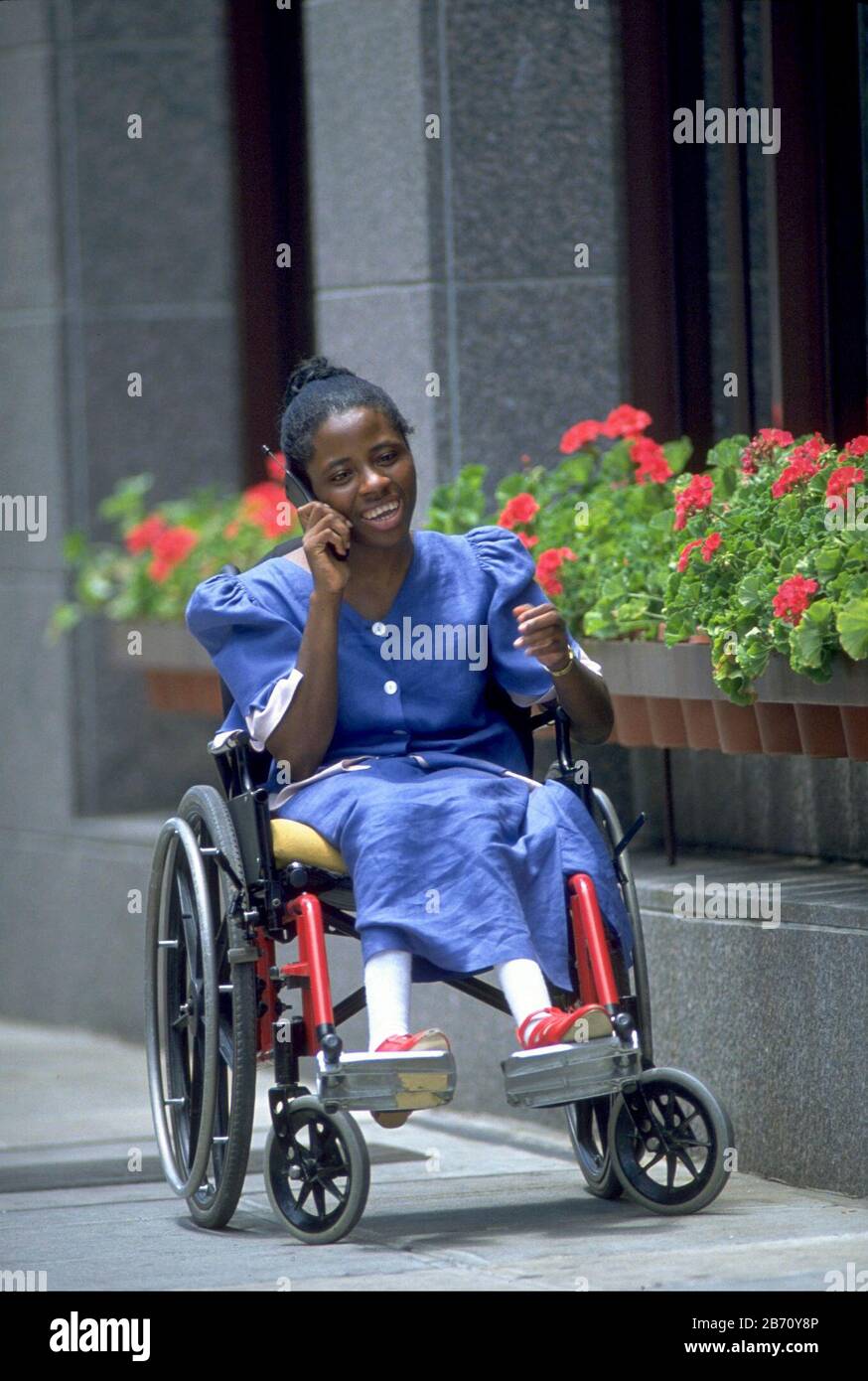 Austin Texas USA: Disabled woman in wheelchair uses a cell phone on ...
