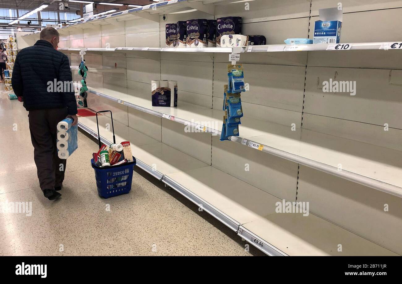Shelves containing a few toilet roll packs in a Tesco store in Dublin ...