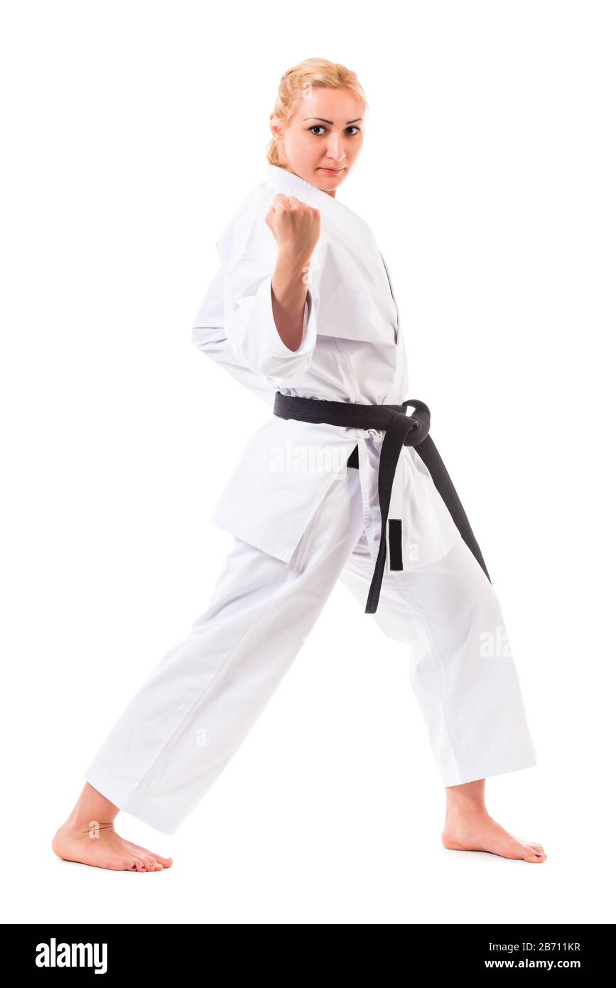 Woman dressed in kimono with black belt and posing in karate stand ...