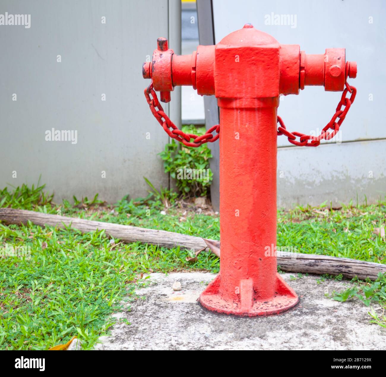 Red Asian Vintage above-ground pillar-type Fire Hydrant at a street ...