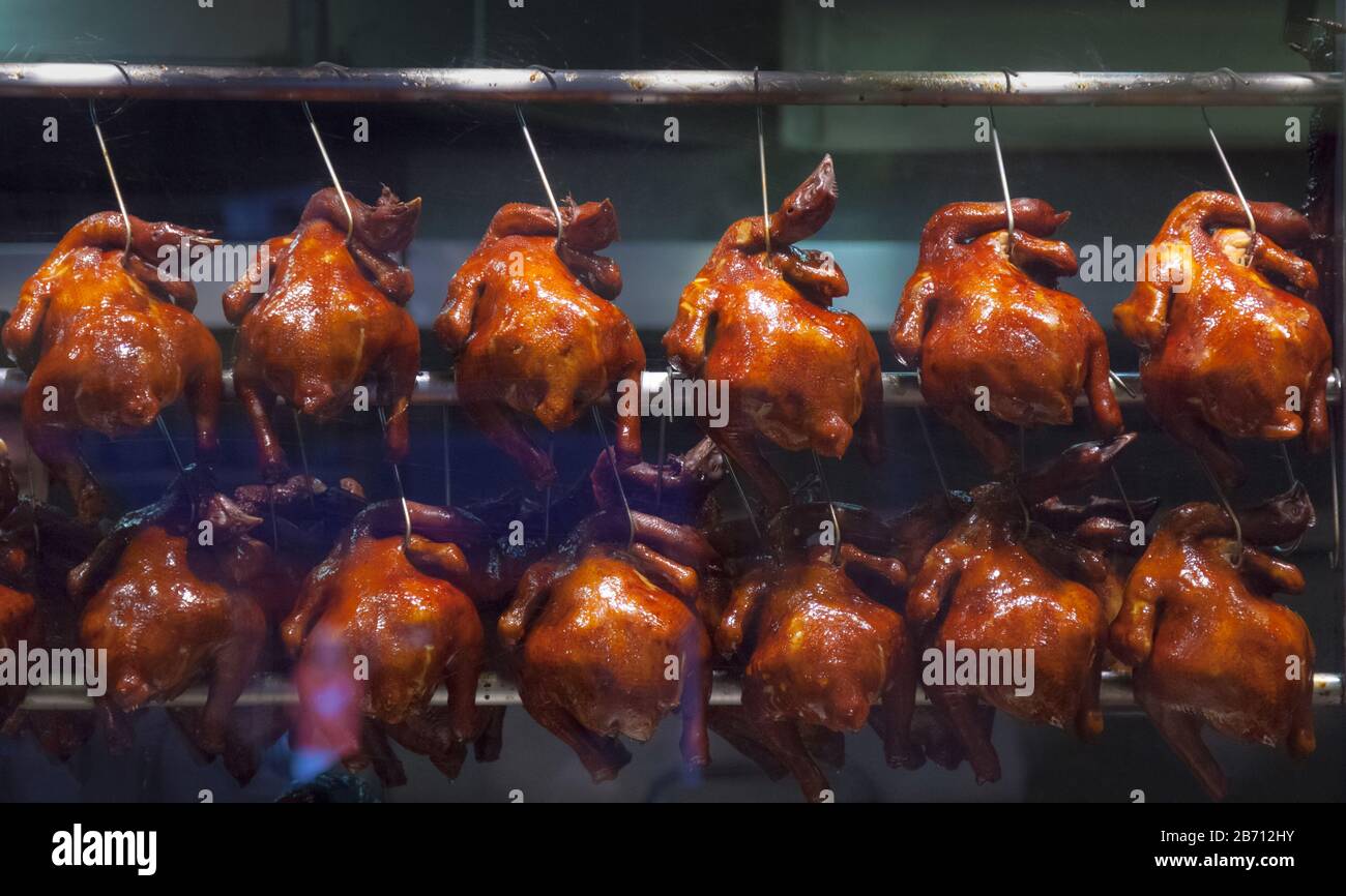 Delicious Soya Sauce Grilled Chickens hung on display in food box at ...