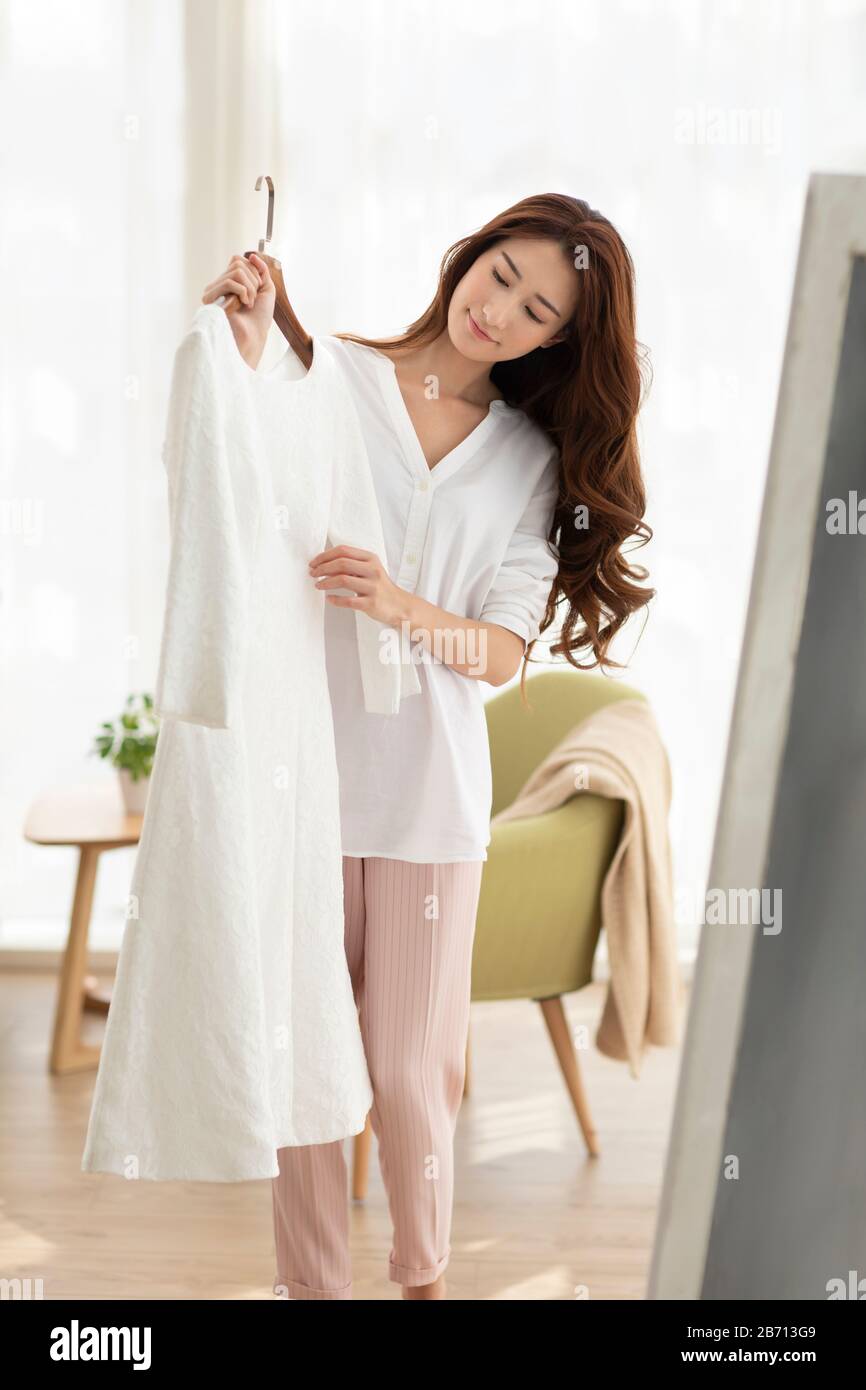 Young woman dressing up at home Stock Photo - Alamy