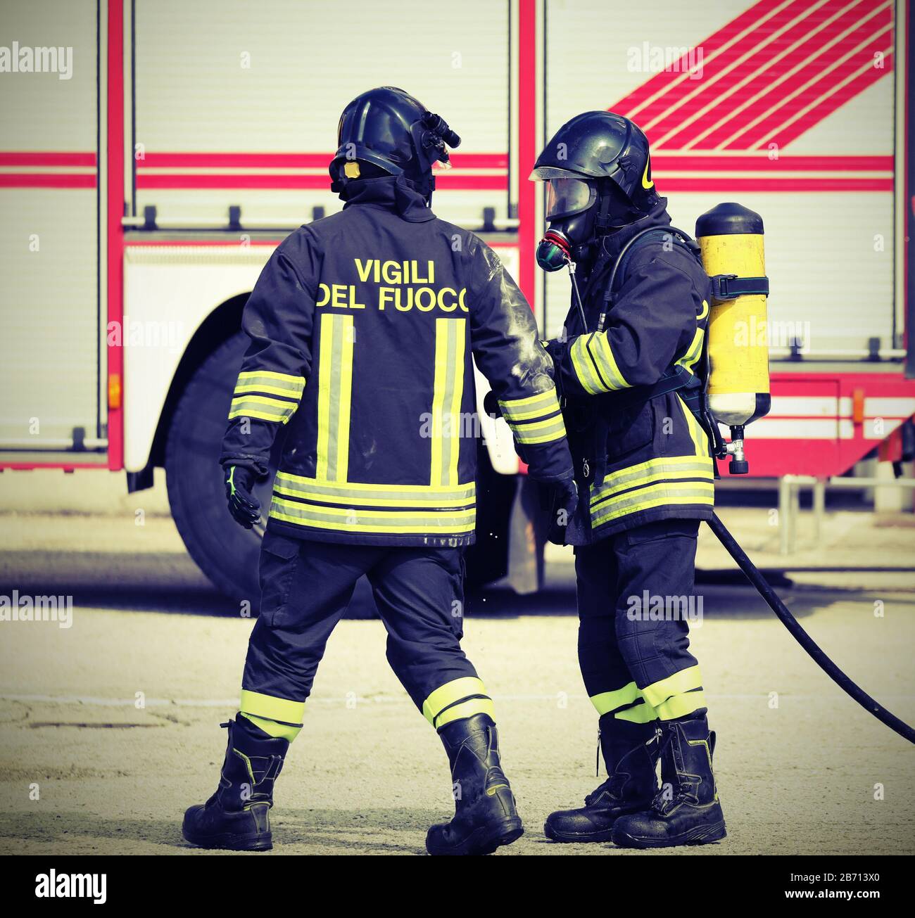 two italian brave firefighters with oxygen cylinders and uniforms with ...