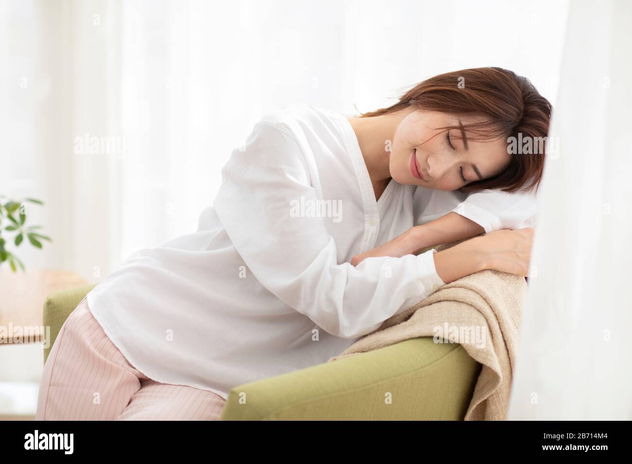 Young Chinese woman resting at home Stock Photo - Alamy