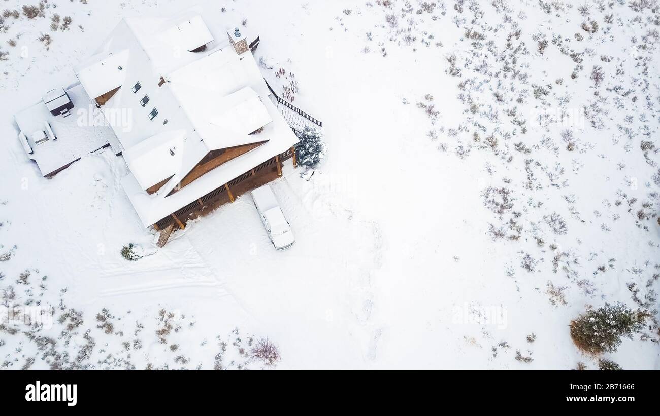Aerial view of the mountain house covered in snow in the Winter Stock ...