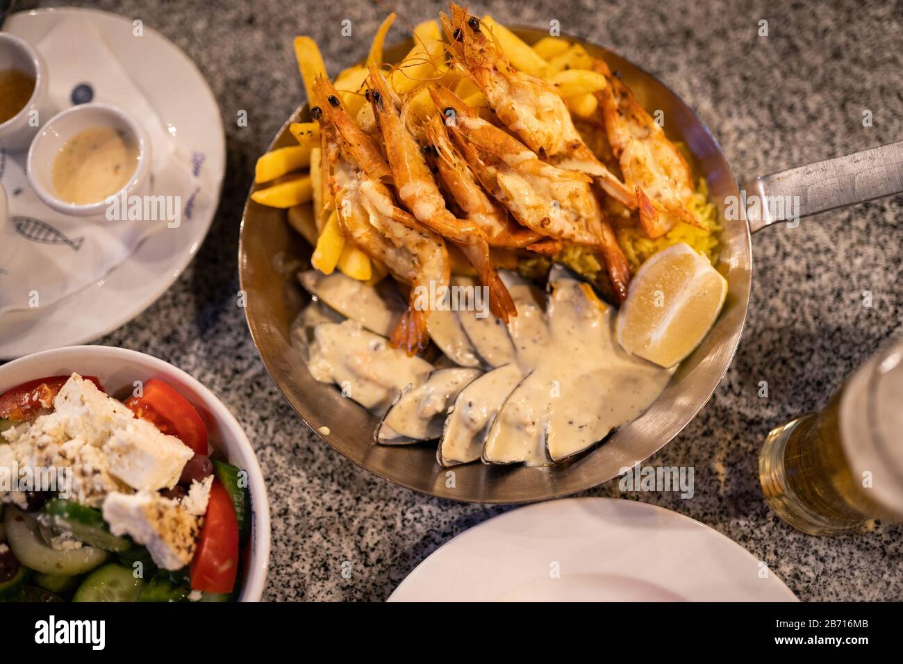 Seafood on the plate with sauce Stock Photo - Alamy