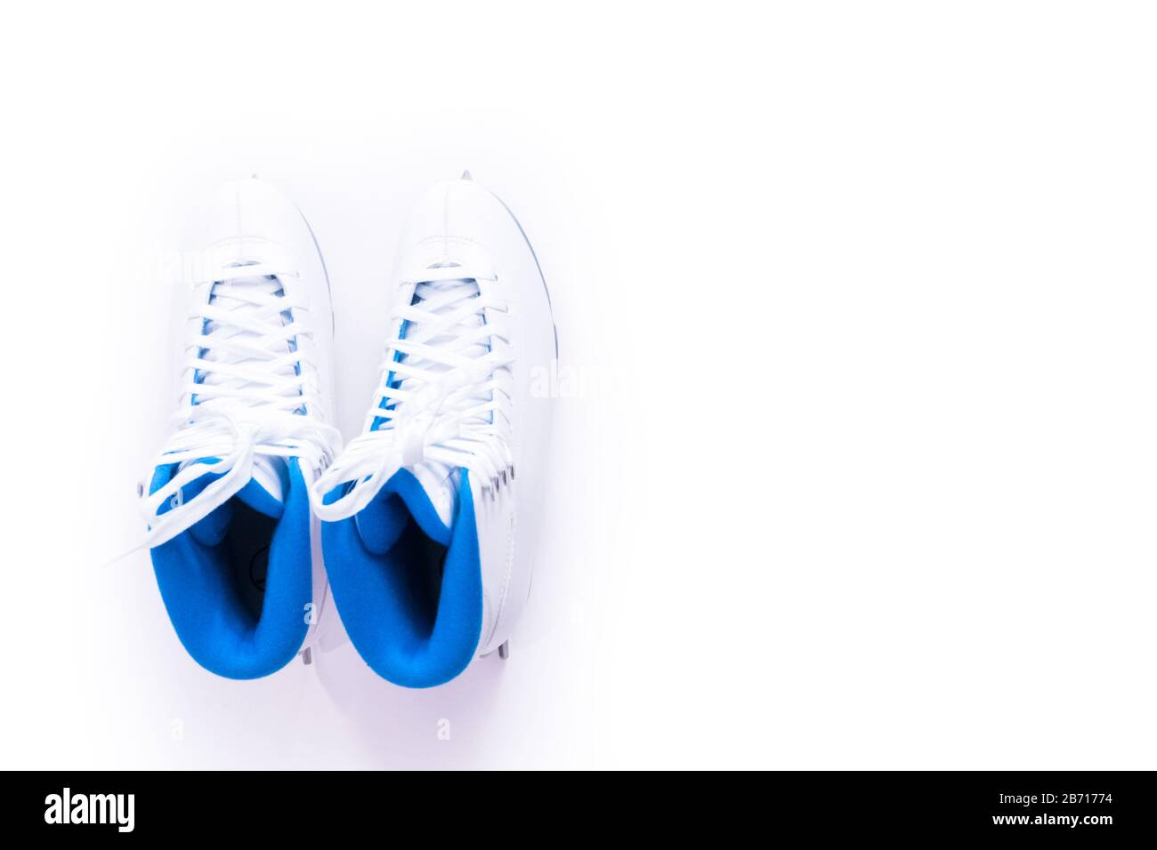 Flat lay. New white figure skates on a white background Stock Photo - Alamy