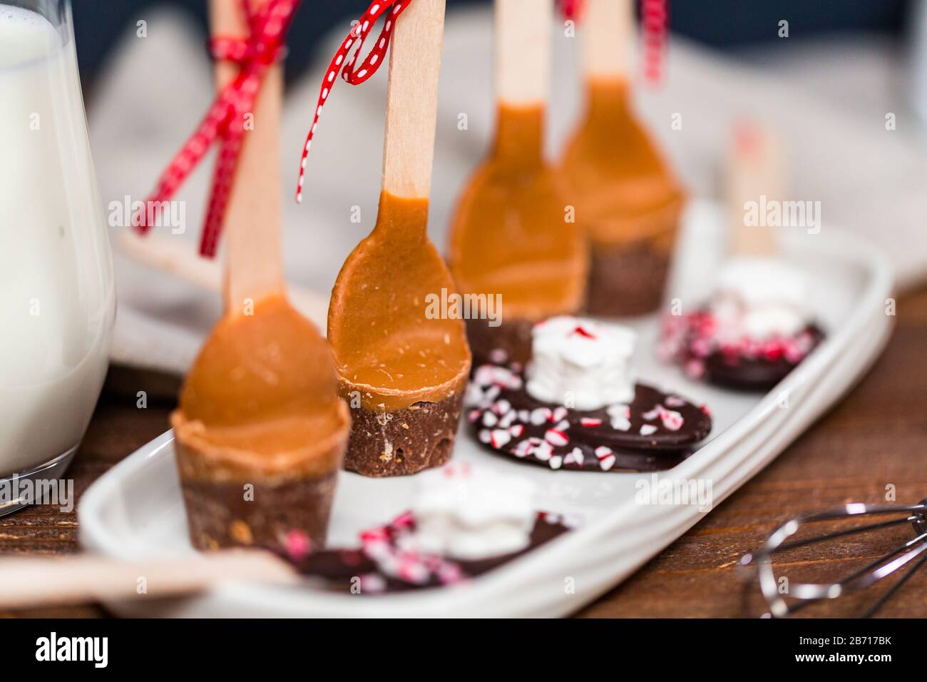 Salted caramel hot cocoa spoons on a white tray Stock Photo - Alamy