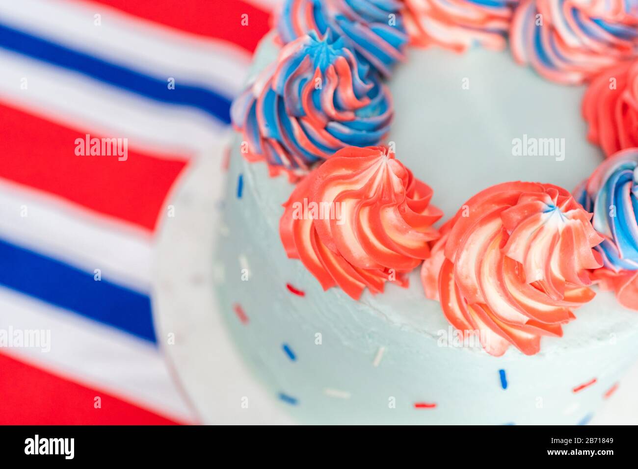 Red, white, and blue round vanilla cake with buttercream frosting for ...