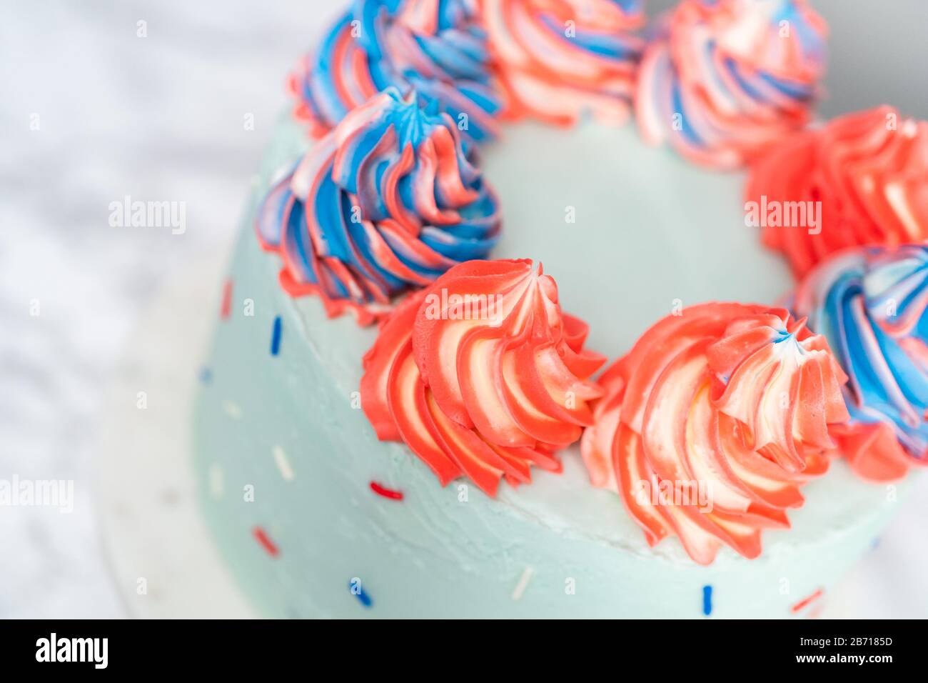 Red, white, and blue round vanilla cake with buttercream frosting for ...