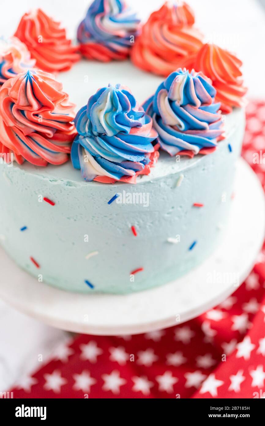 Red, white, and blue round vanilla cake with buttercream frosting for ...