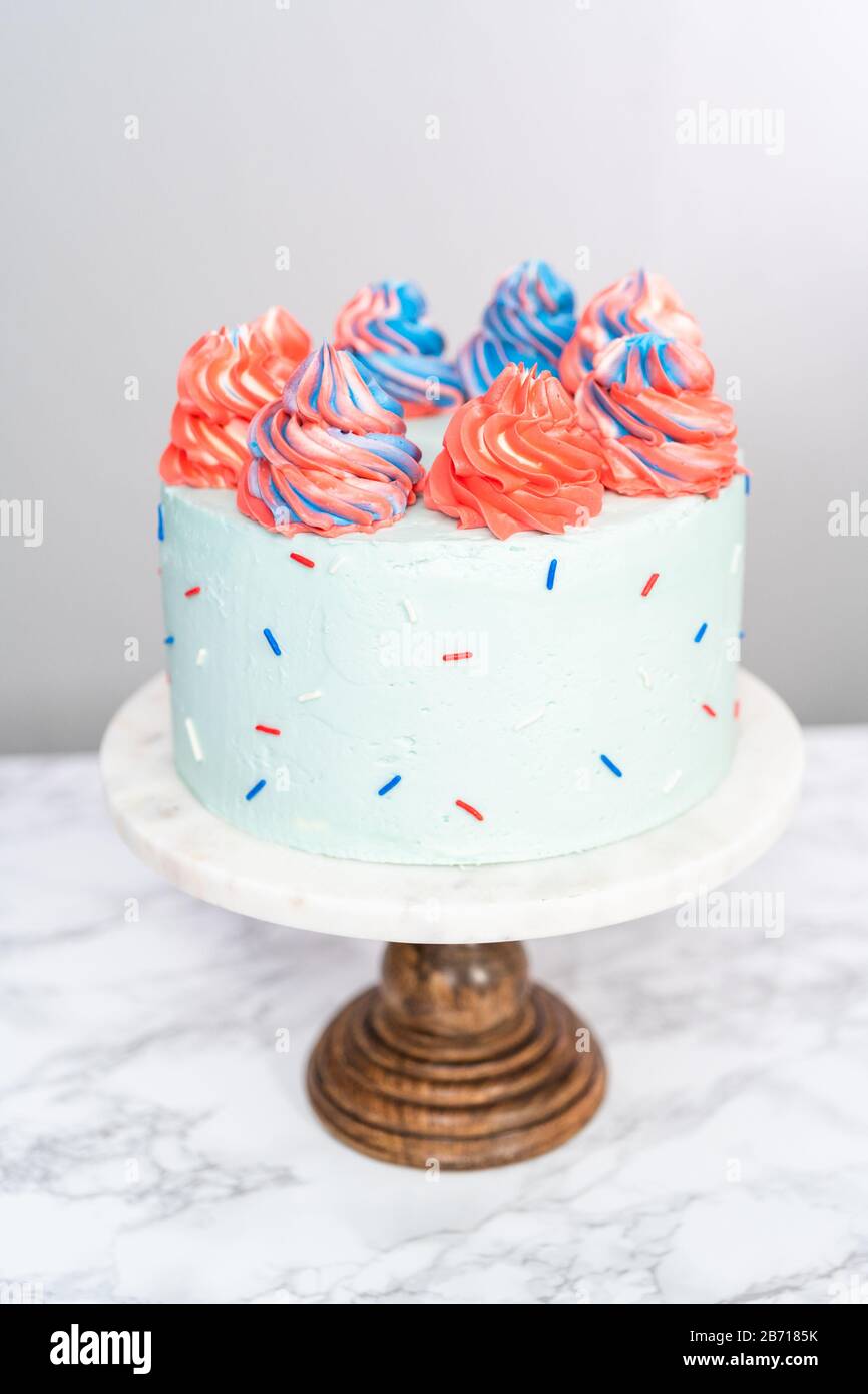 Red, white, and blue round vanilla cake with buttercream frosting for ...