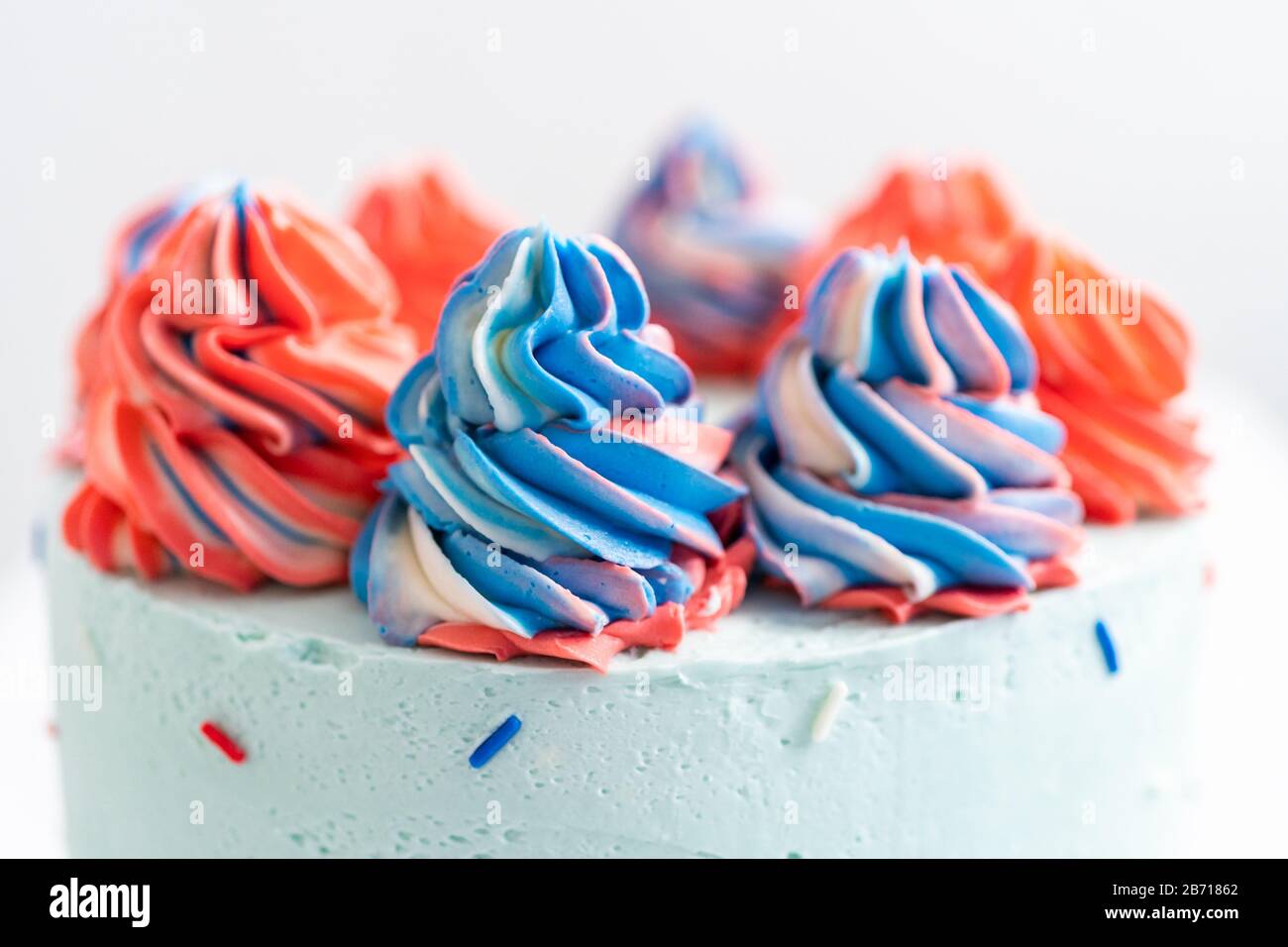 Red, white, and blue round vanilla cake with buttercream frosting for ...