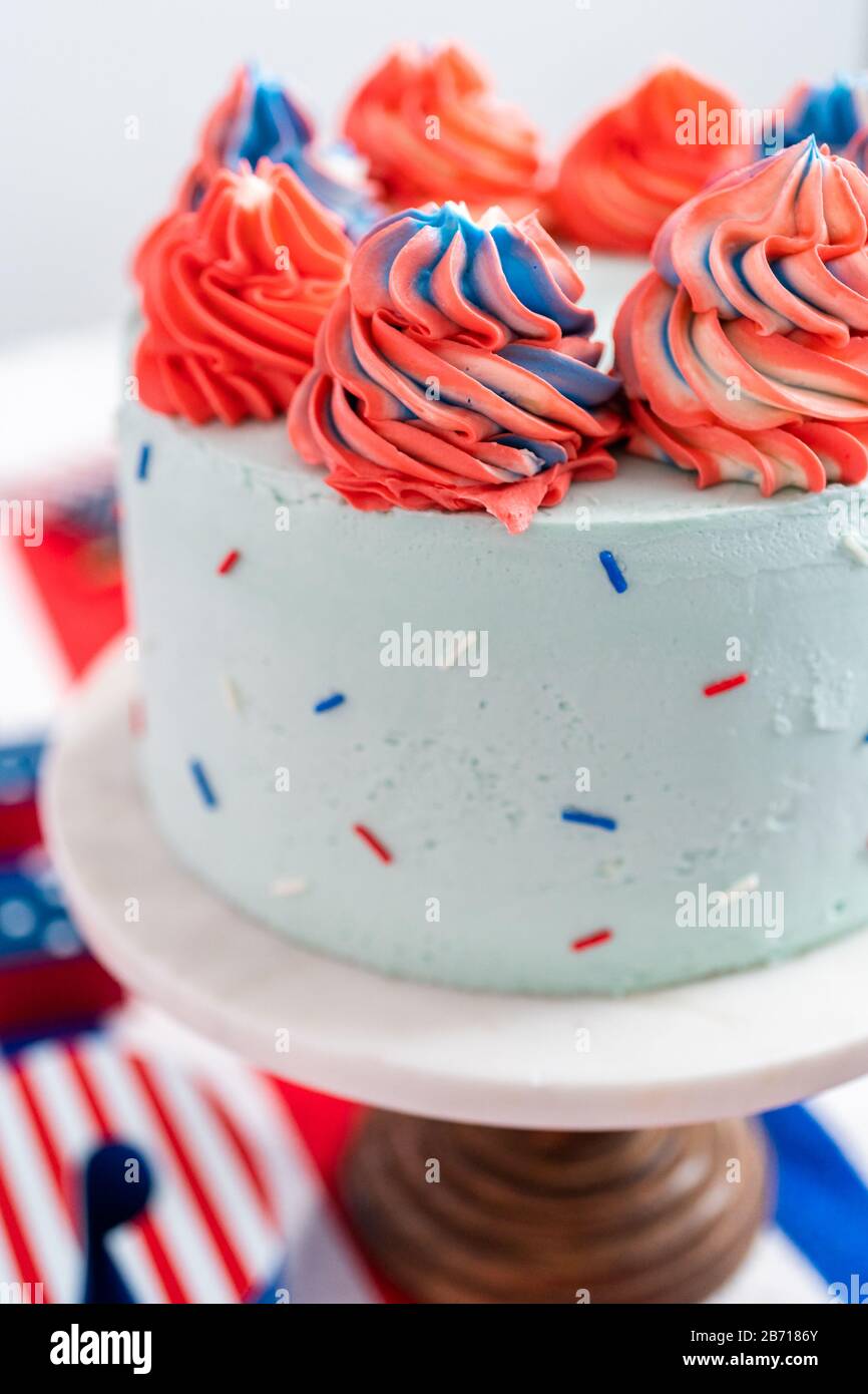 Red, white, and blue round vanilla cake with buttercream frosting for ...